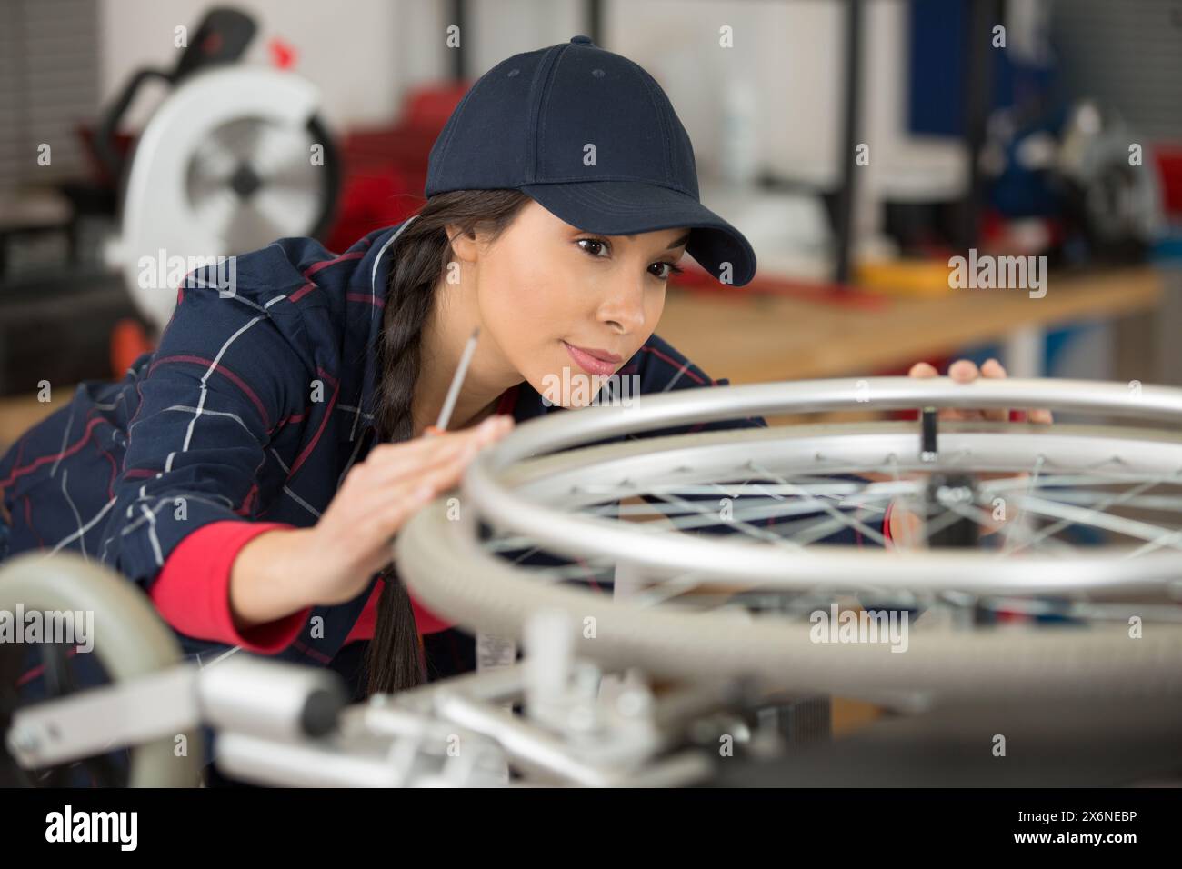 female worker is fixing a wheelchair Stock Photo - Alamy
