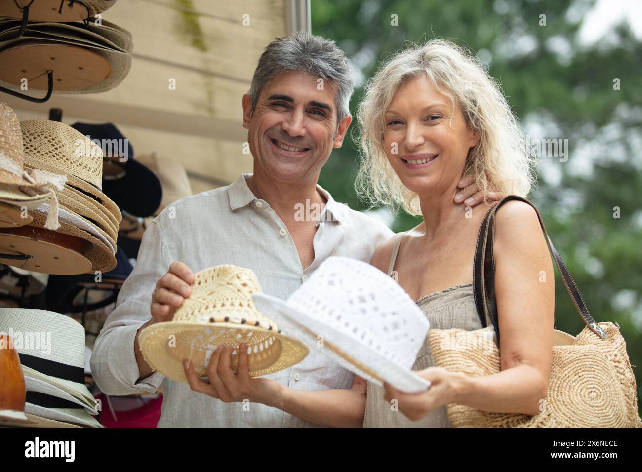 Woman choosing summer hat hi-res stock photography and images - Alamy