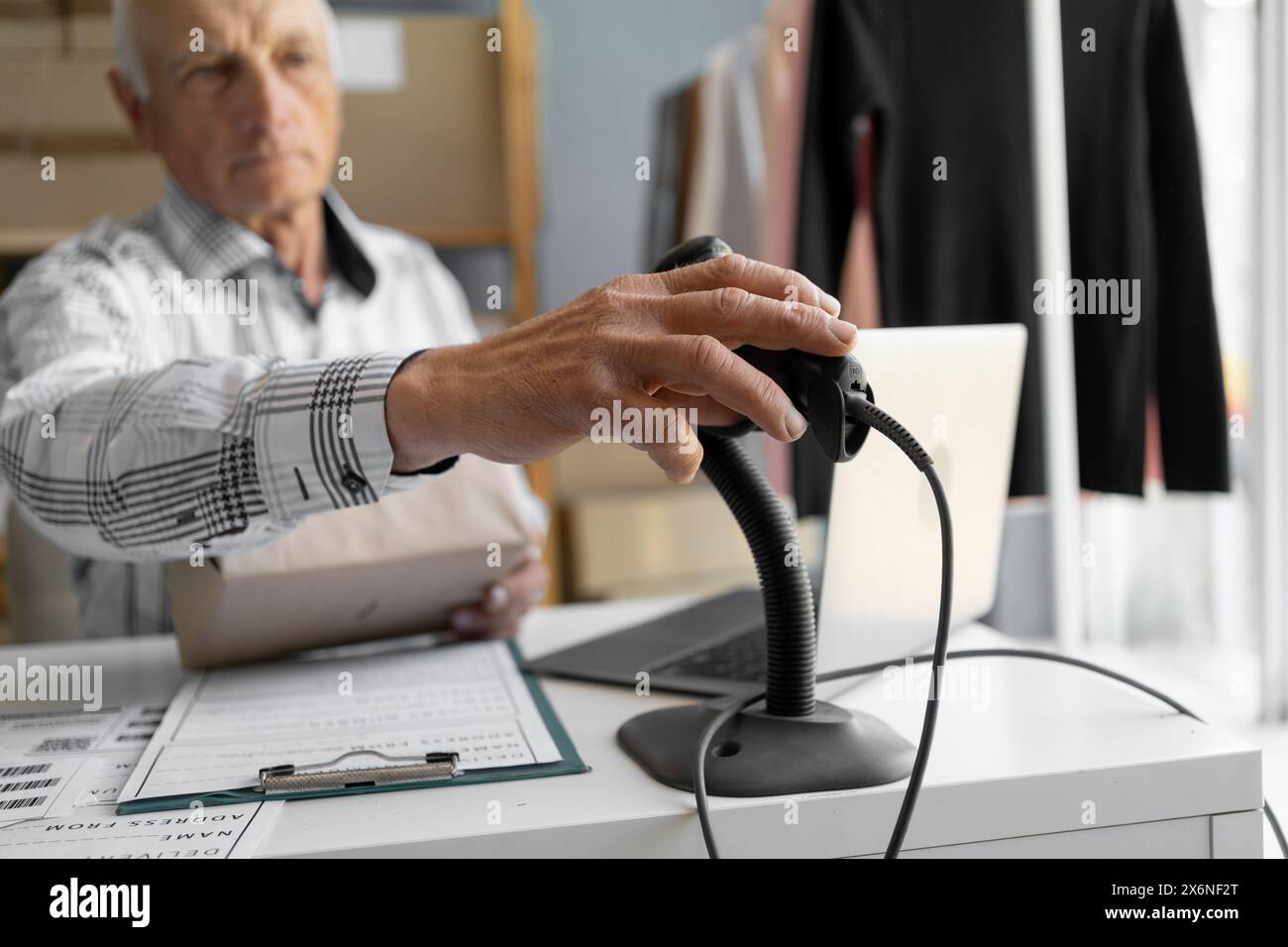 The businessman takes scanner to scan data about the parcel. Delivery ...