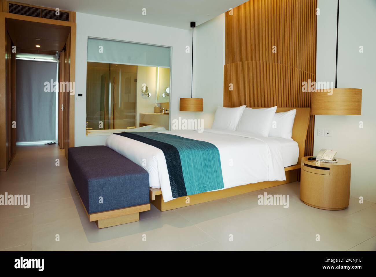 A luxurious yet minimalist bedroom design featuring a comfortable bed ...