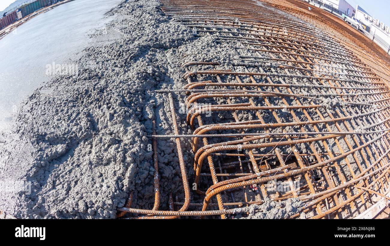 Construction concrete pouring onto steel rebar flooring of new ...