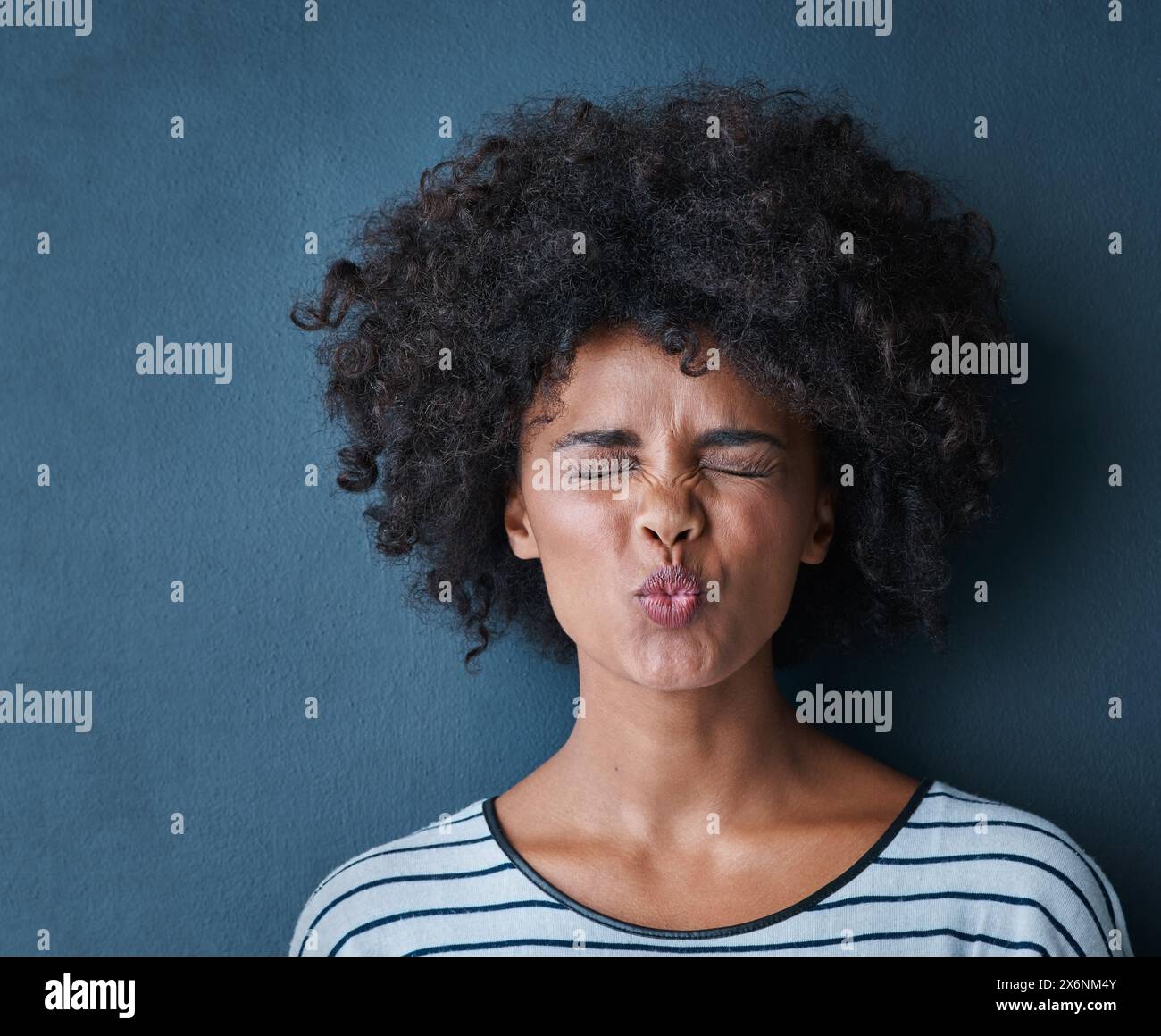 Portrait, emoji and lady with kissing expression in studio for fun ...