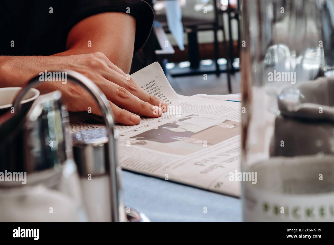 Man reading a newspaper while drinking coffee in a restaurant Stock ...