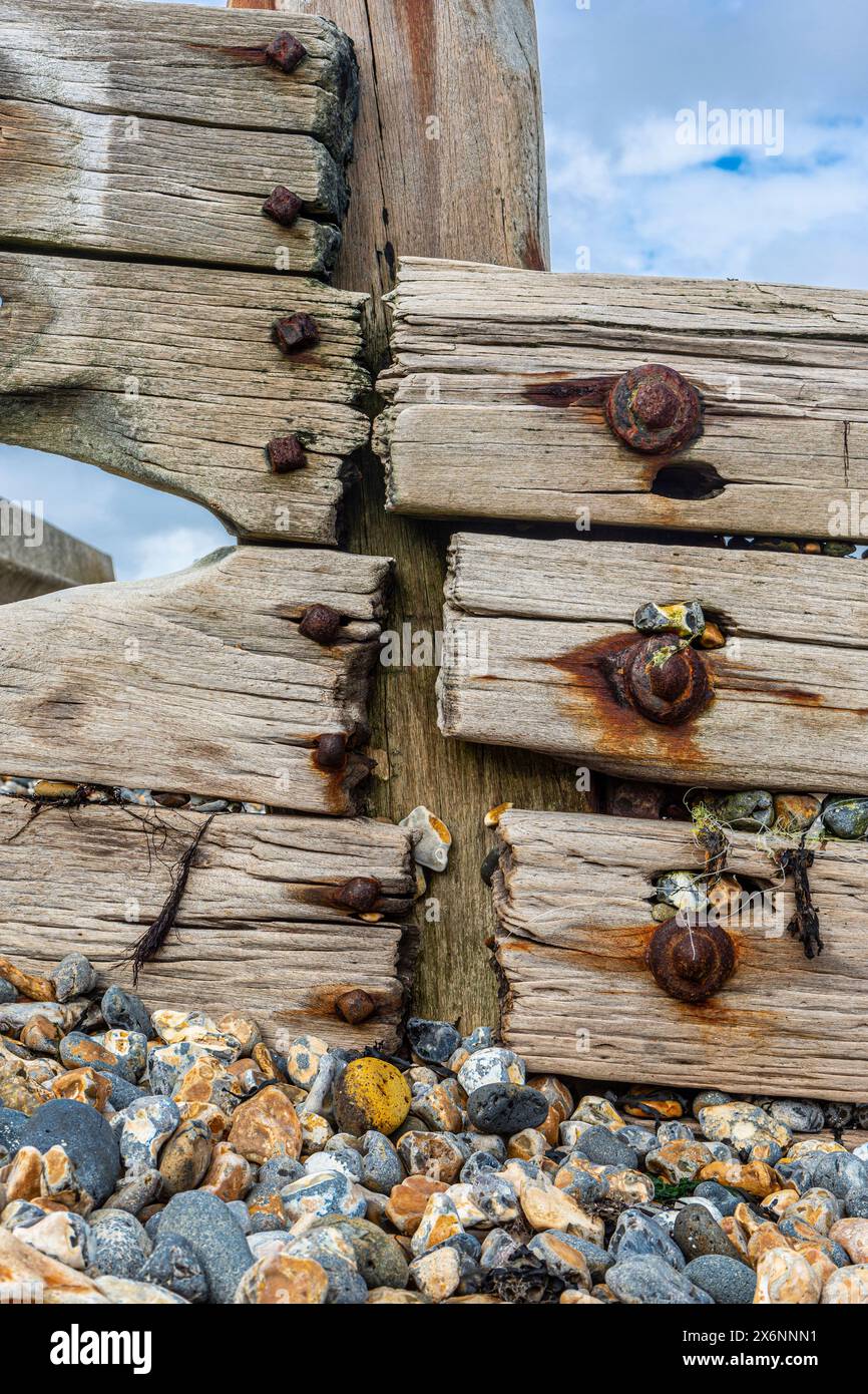 A close up of an old, worn, wooden groyne on a shingle beach Stock ...