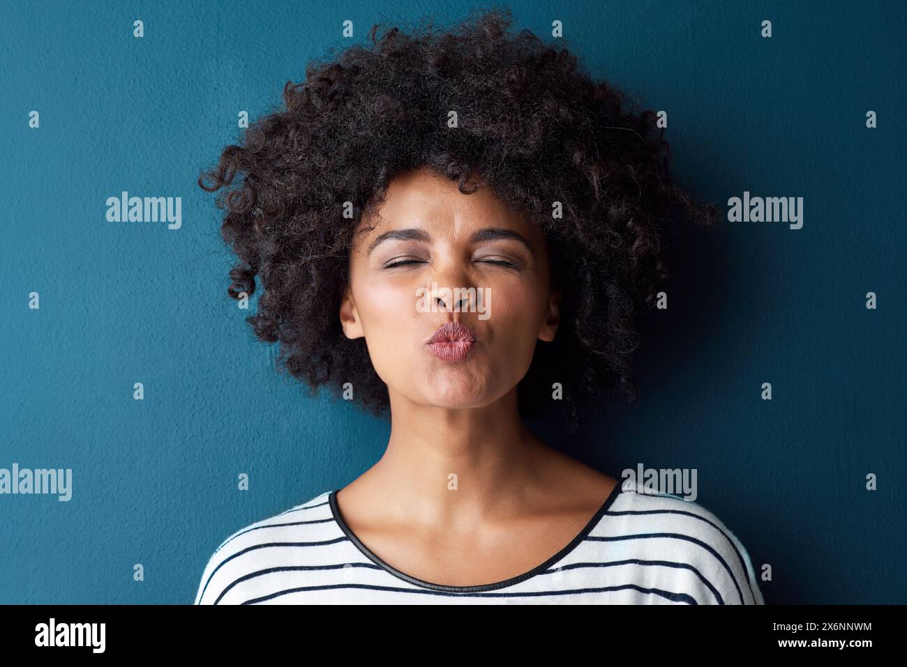 Portrait, emoji and kissing with facial expression in studio for fun ...