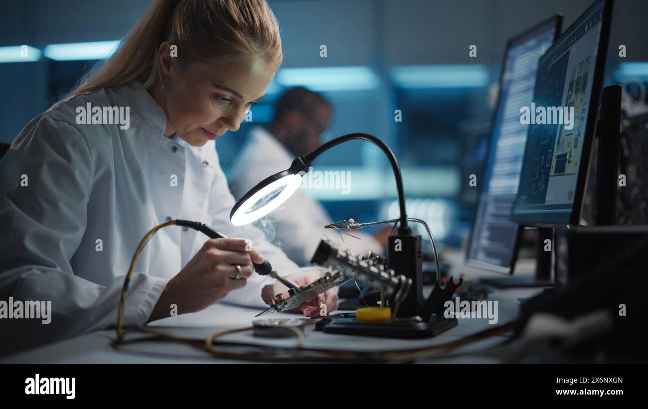 Modern Electronics Research and Development Facility: Beautiful Caucasian Female Engineer Does ...
