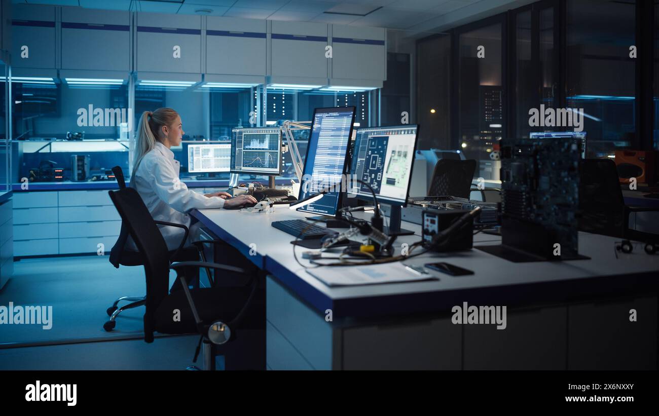 Modern Electronics Development Facility: Female Engineer Works alone on ...