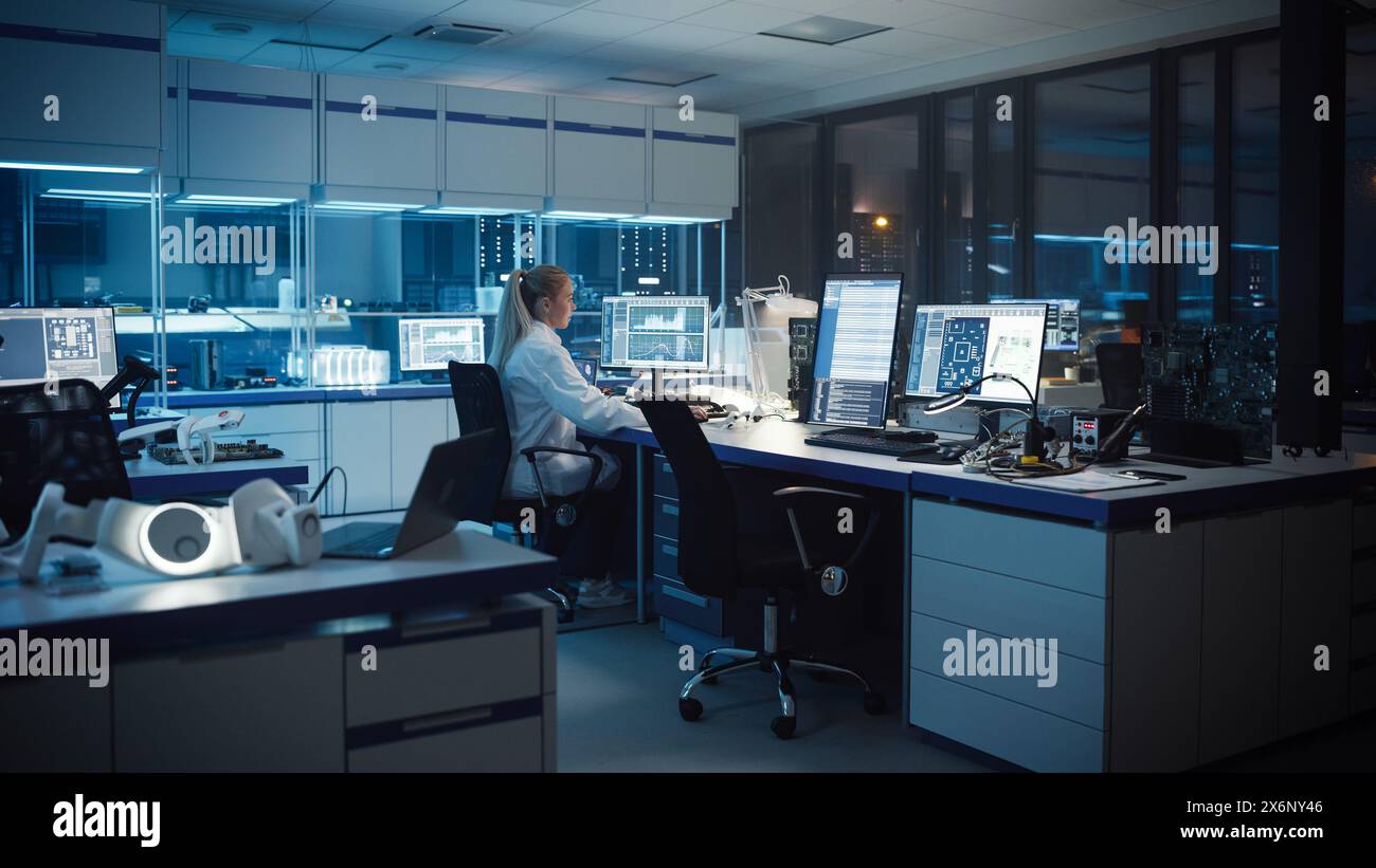 Modern Electronics Development Facility: Female Engineer Works alone on ...