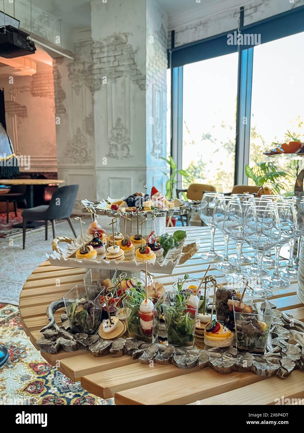 Catering buffet with sweet and savory appetizers, fruit platter with ...