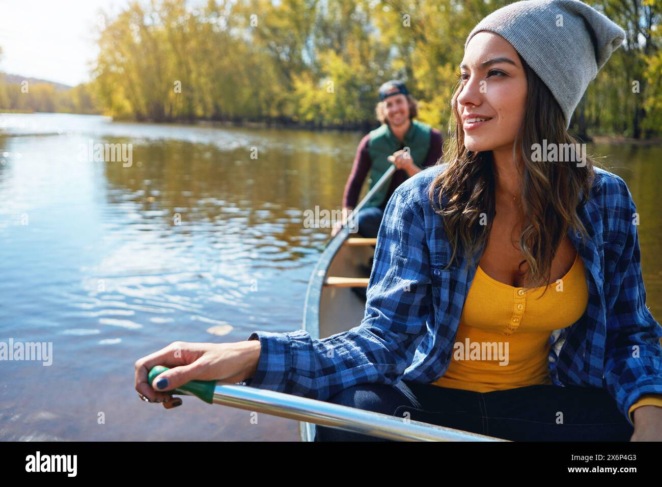 Lake, canoe and couple with nature, happiness and hobby with vacation ...