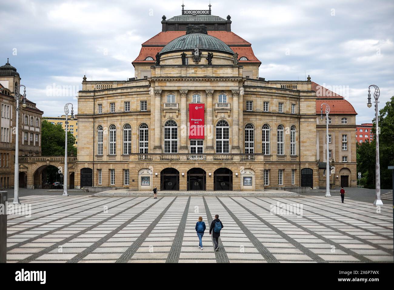 Chemnitz, Germany. 16th May, 2024. Passers-by walk across Theaterplatz ...