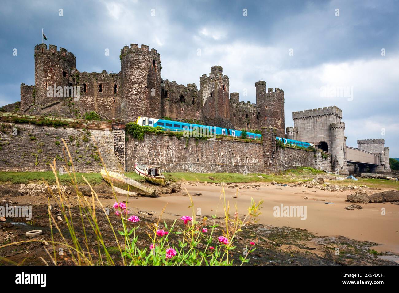 Arriva diesel multiple unit passes Conwy castle. Conway Stock Photo - Alamy