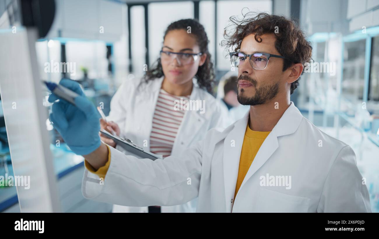 Medical Science Laboratory: Handsome Latin Male Scientist Writes ...