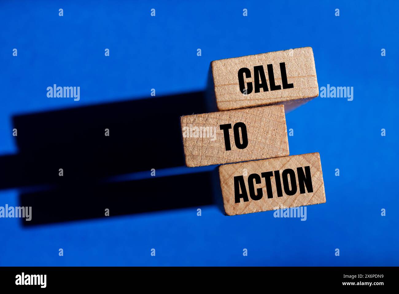 Call to action words written on wooden blocks with blue background ...