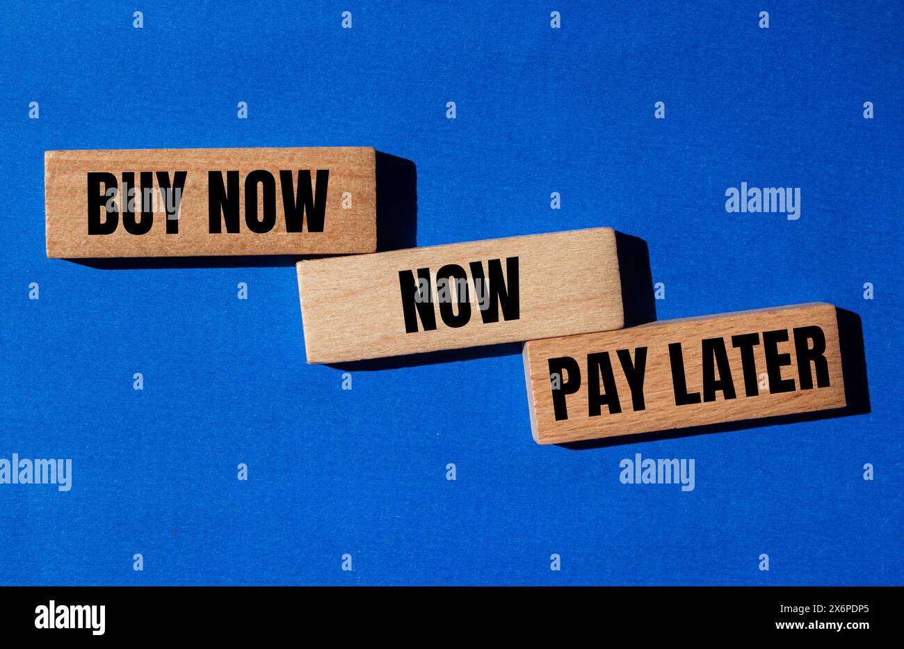 Buy now pay later words written on wooden blocks with blue background ...