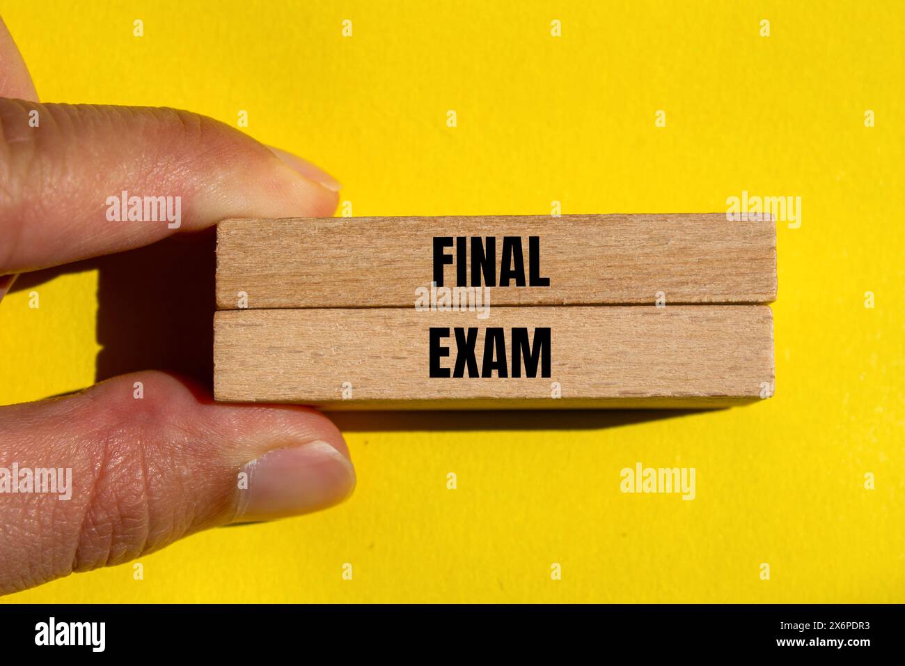 Final exam words written on wooden blocks with yellow background ...