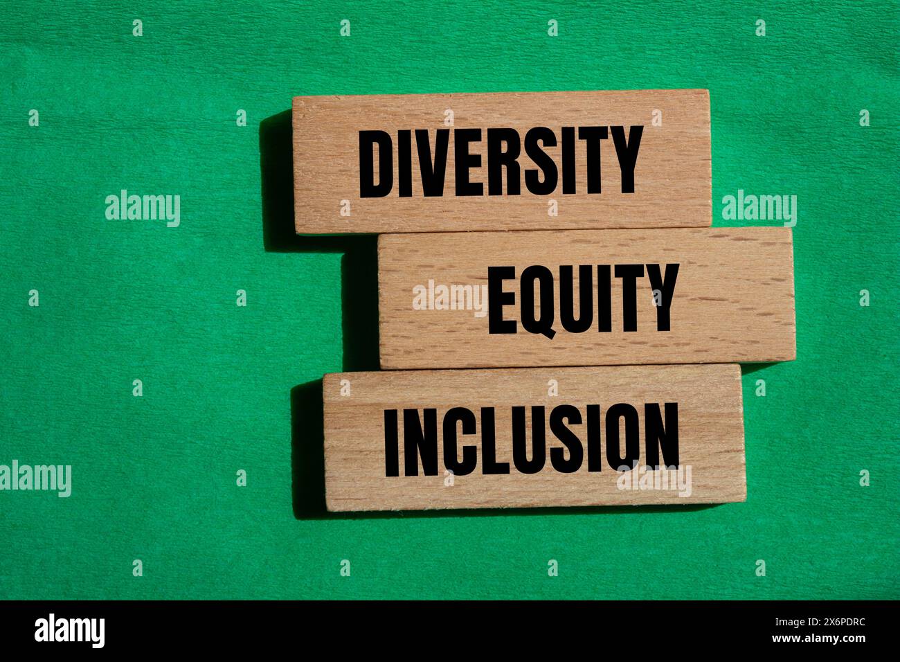 Diversity, equity and inclusion words written on wooden block with ...