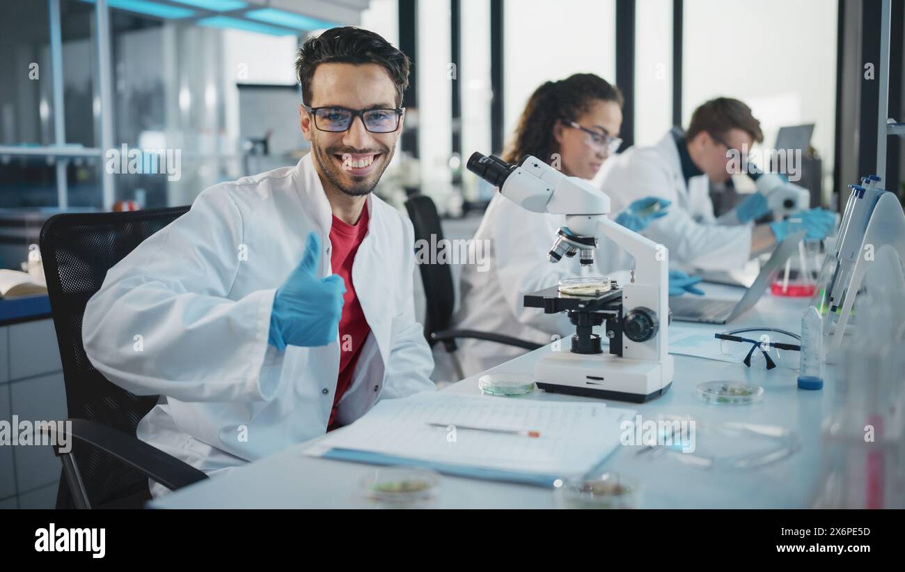 Medical Science Laboratory: Handsome Scientist is Using Microscope for ...