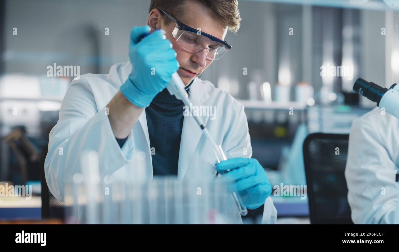 Modern Medical Laboratory: Young Caucasian Male Research Scientist ...