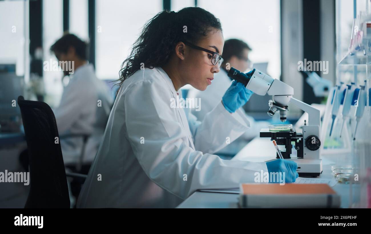 Medical Science Laboratory: Beautiful Black Scientist Looking Under ...