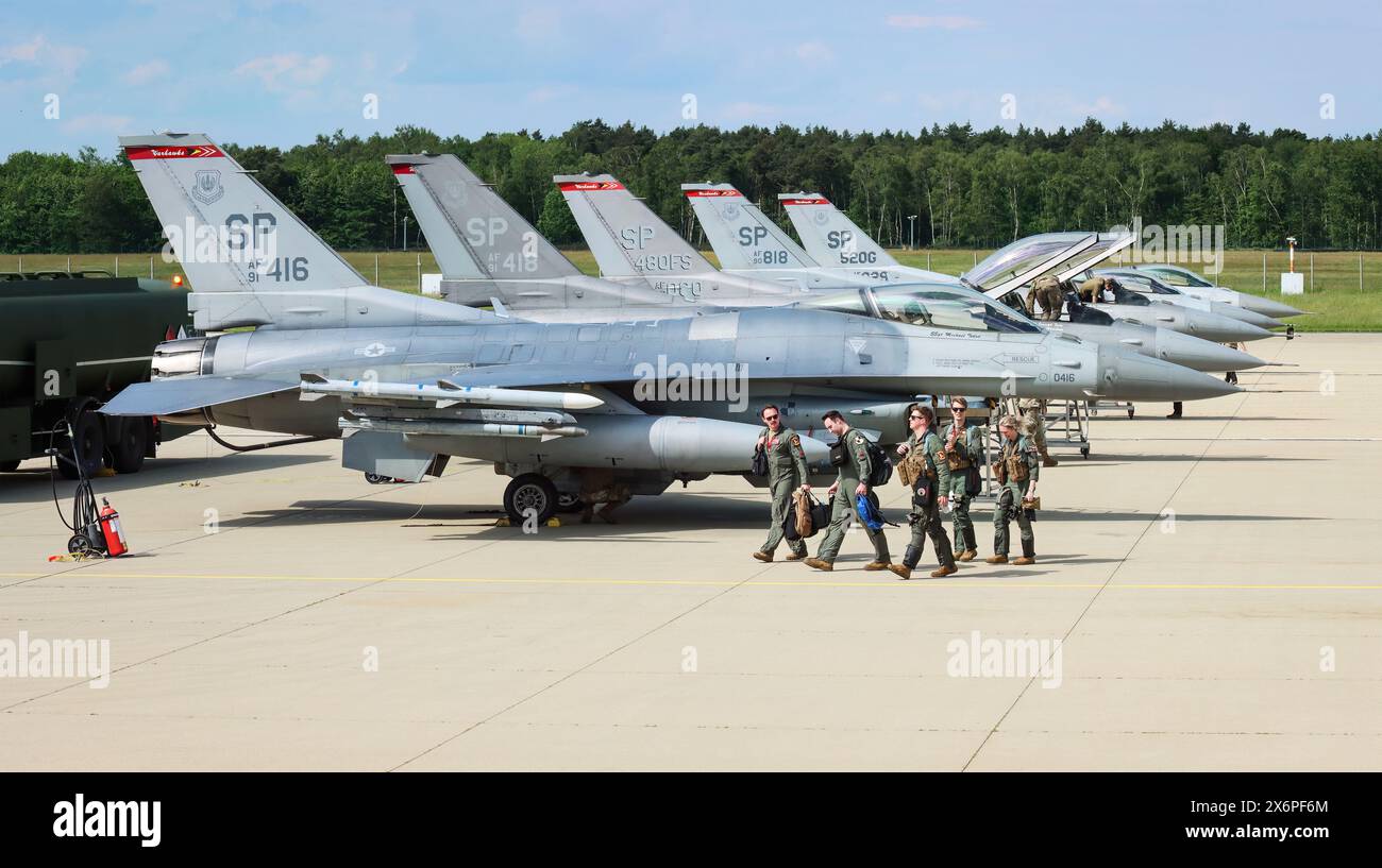 Pilots assigned to the 480th Fighter Squadron walk on the flightline ...