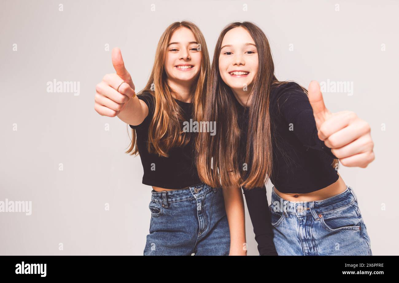 Two Young pre teen best friend girl on studio white Stock Photo - Alamy