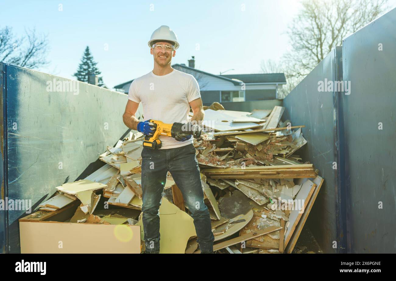Construction Worker outside of house put old renovation material on big ...