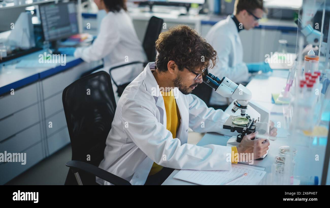 Medical Science Laboratory: Handsome Latin Scientist Looking Under ...