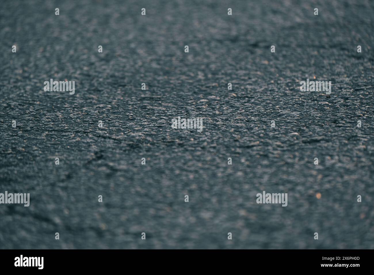 A close-up view of an asphalt road surface, highlighting its detailed ...