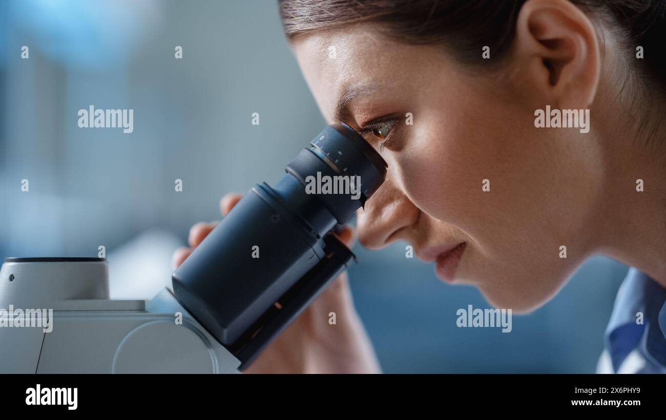 Macro Close-Up Shot of a Beautiful Female Scientist Looking into the ...