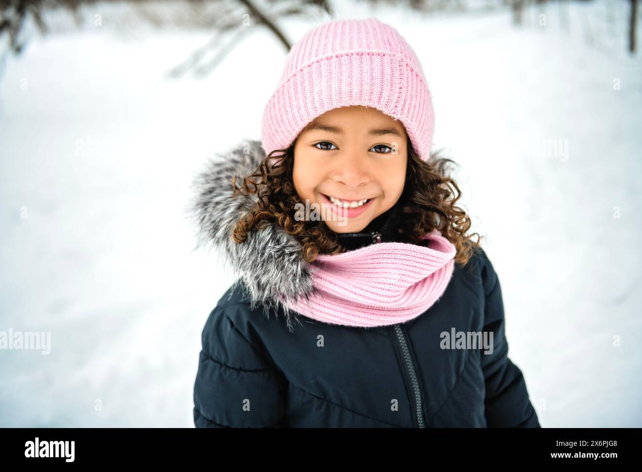 American child girl during snowfall in winter park Stock Photo - Alamy