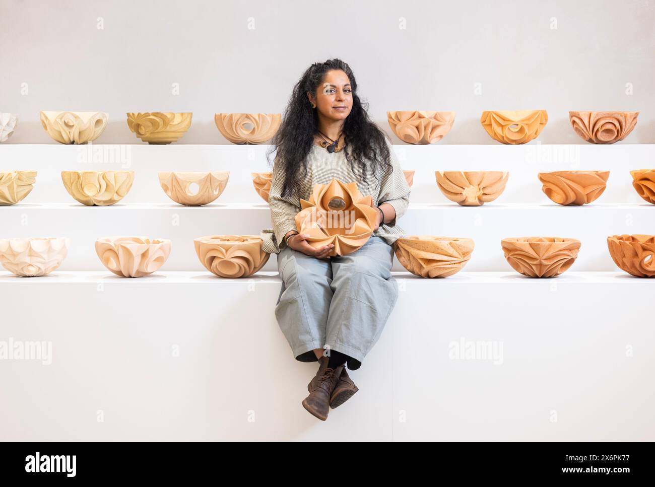 EDITORIAL USE ONLY Sculptor Halima Cassell with her work on display at ...