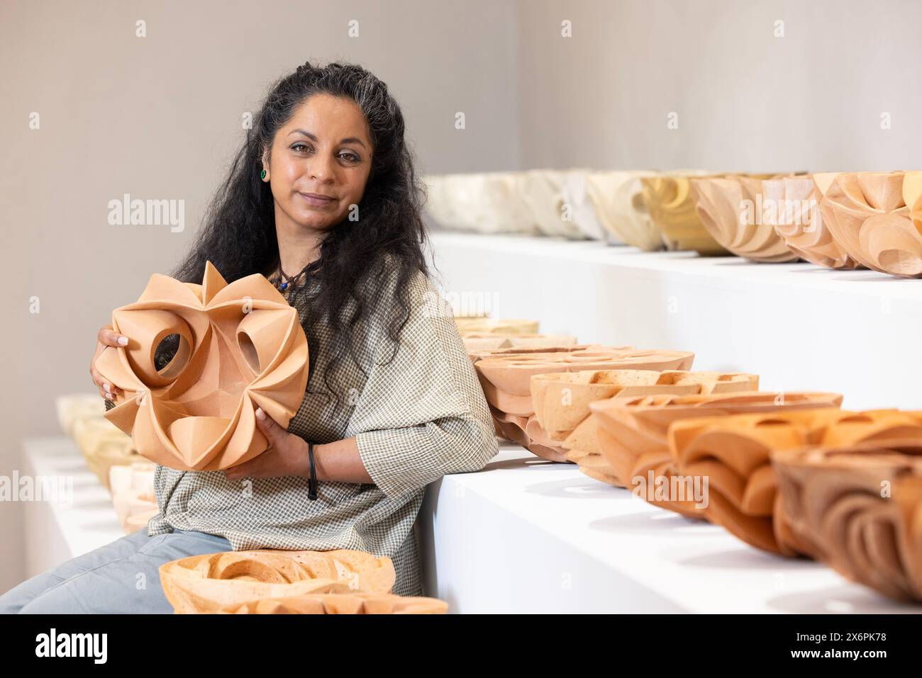 EDITORIAL USE ONLY Sculptor Halima Cassell with her work on display at ...