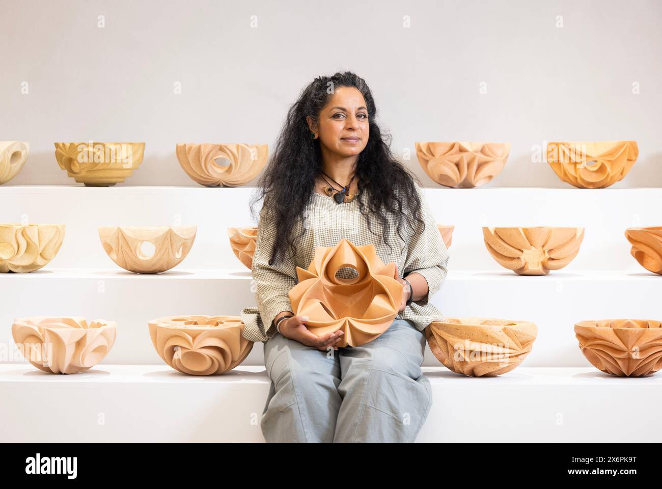EDITORIAL USE ONLY Sculptor Halima Cassell with her work on display at ...