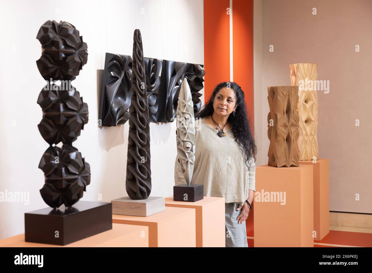 EDITORIAL USE ONLY Sculptor Halima Cassell with her work on display at ...