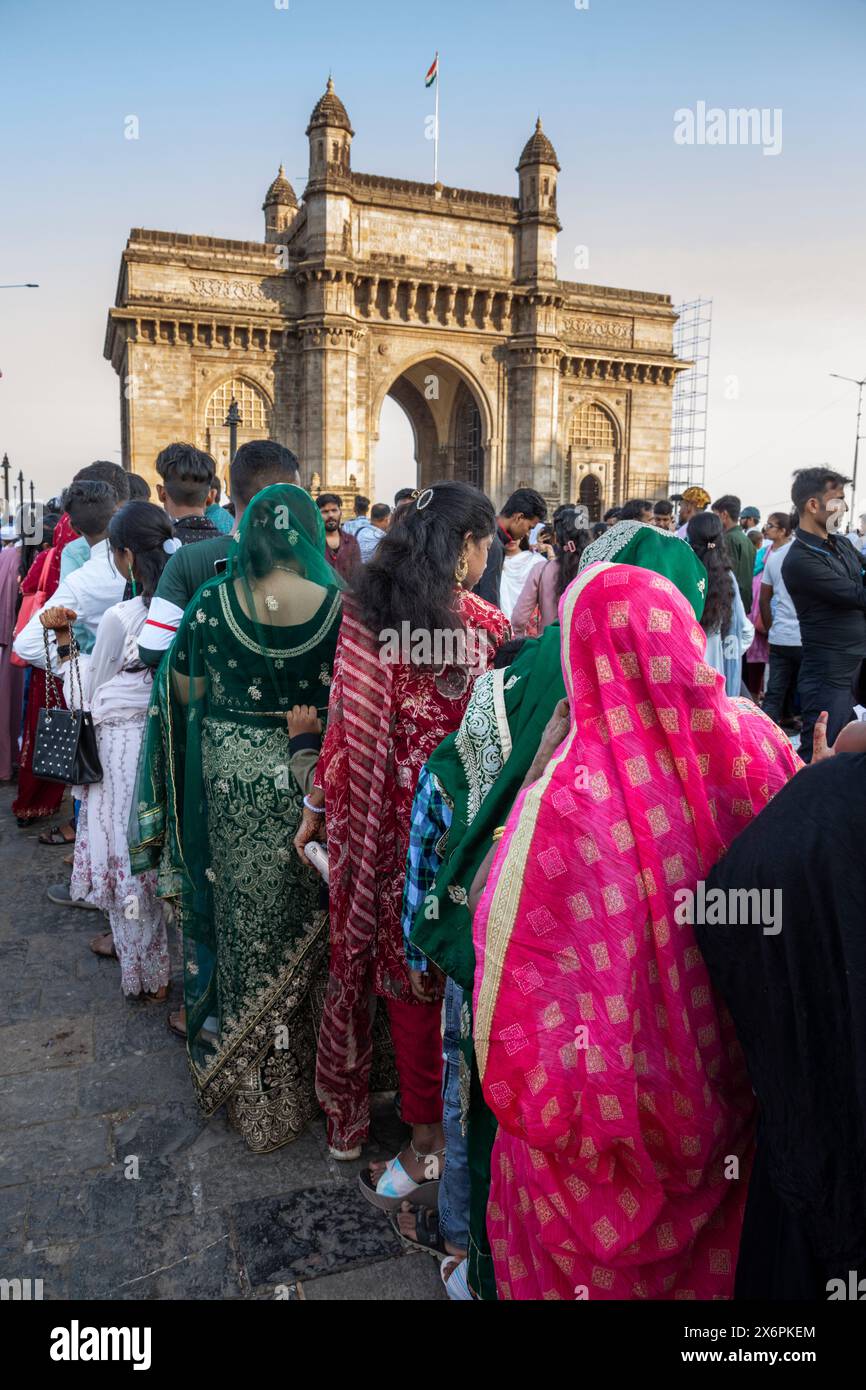 Local women in colourful dress below the Gateway of India, Mumbai ...