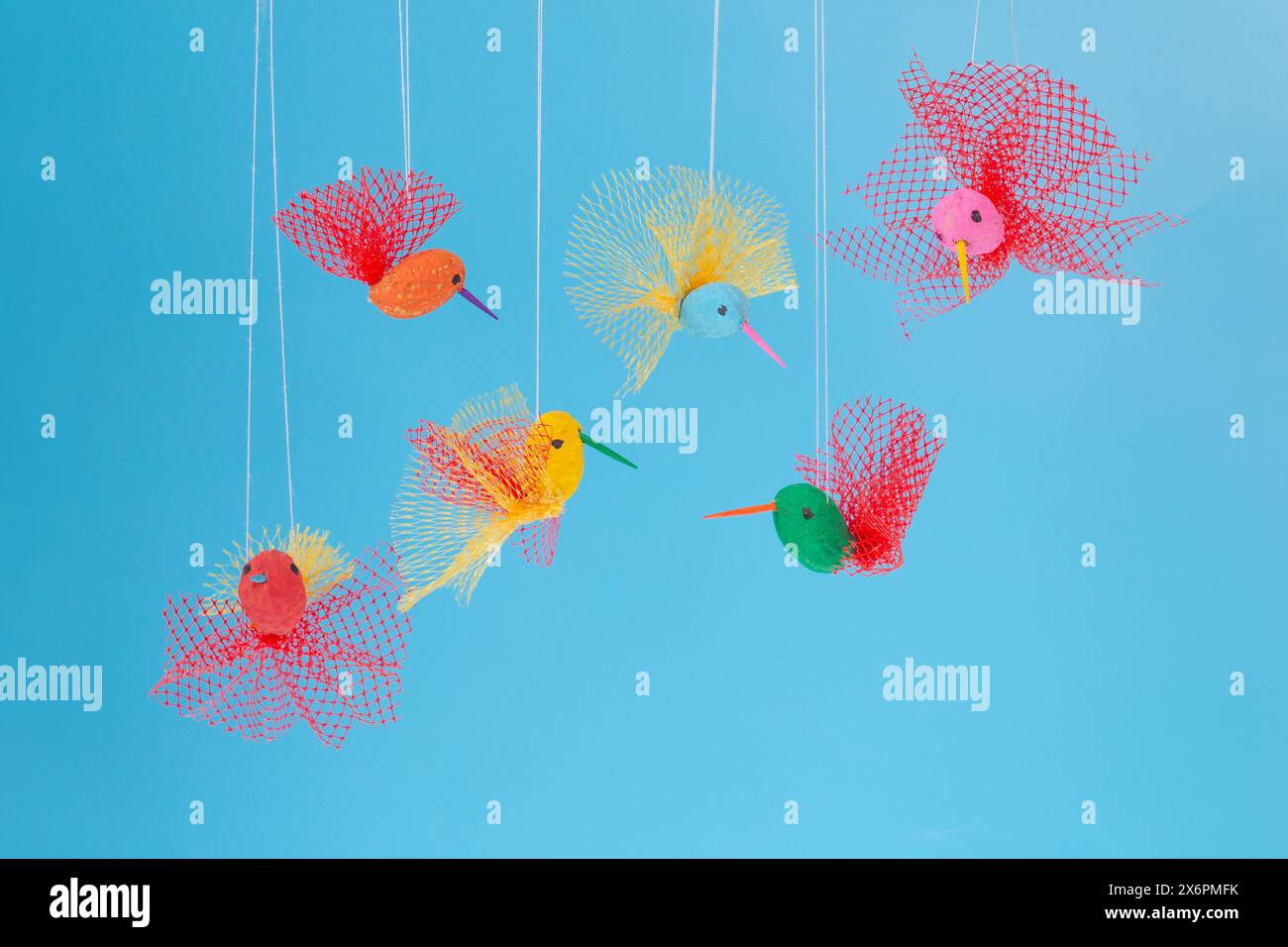 Colorful hummingbird figures crafted from small inshall peanuts ...