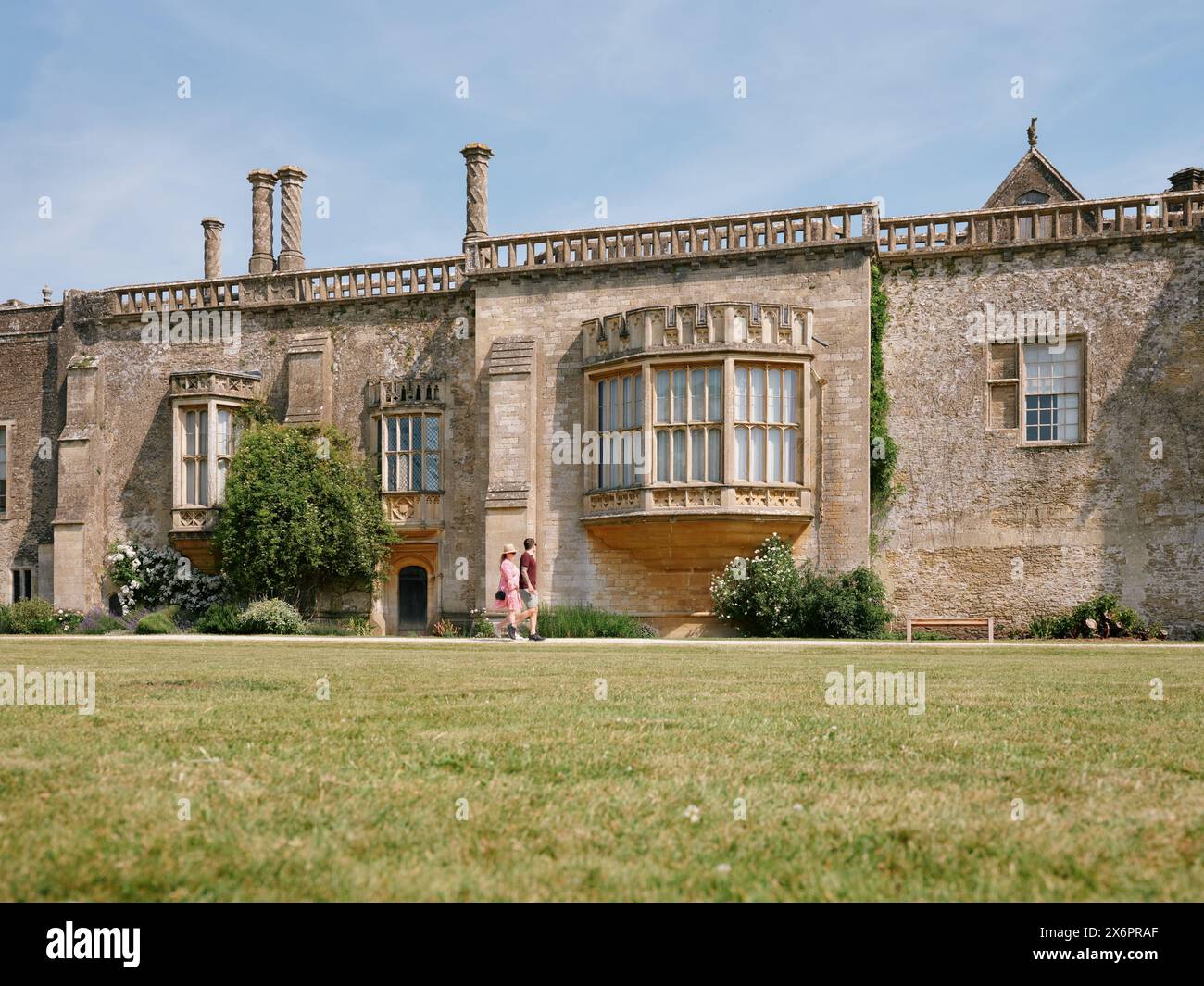 Summer visitors walking around Lacock Abbey in summer, Wiltshire ...