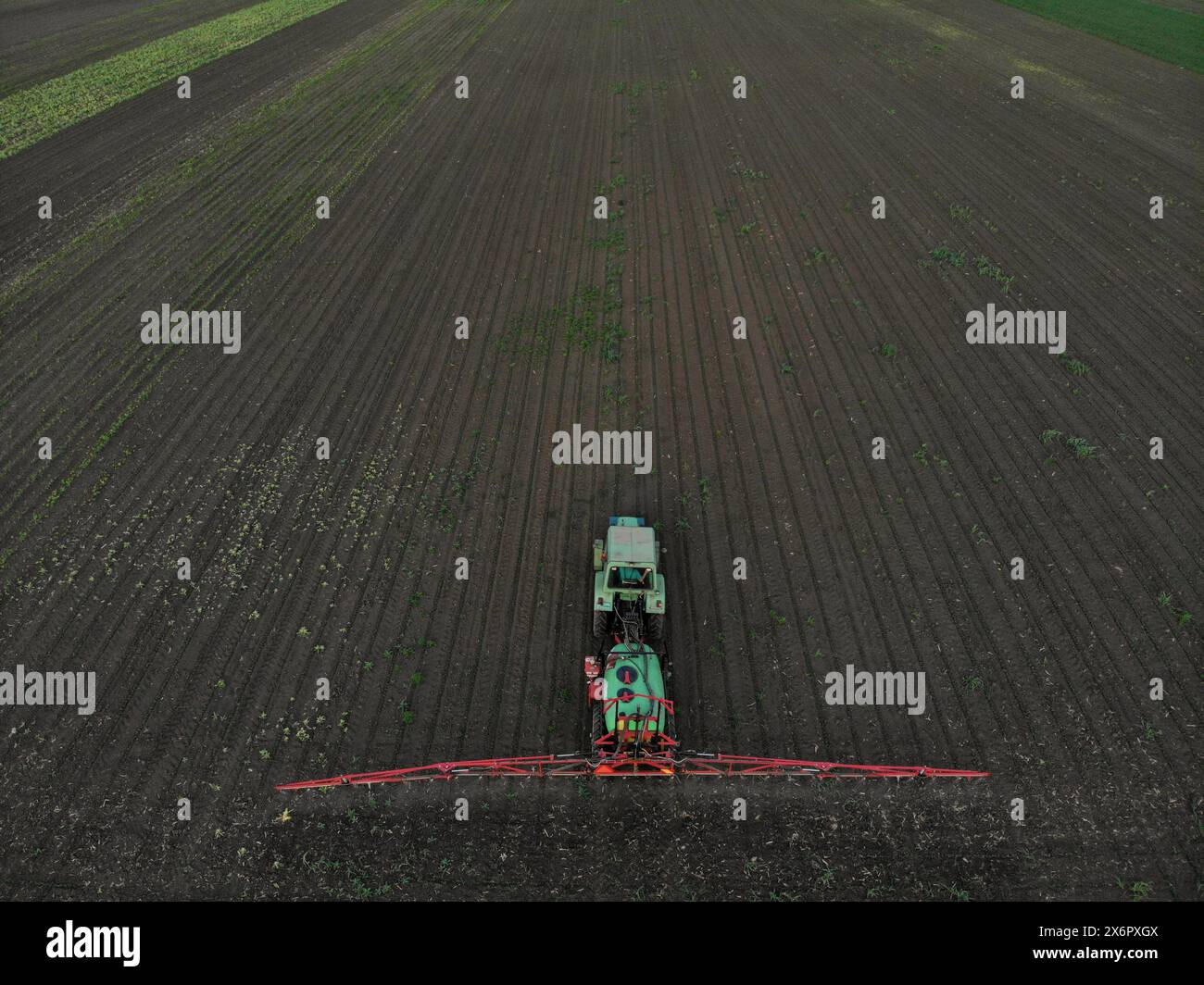 Aerial Shot of Tractor Spray Insecticide, Spraying Pesticides On ...