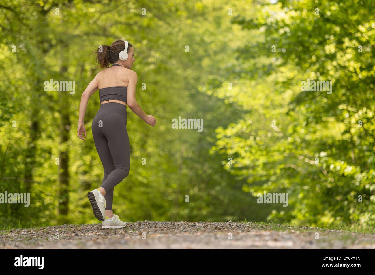 sporty woman running in the countryside on a trail. outdoor fitness ...