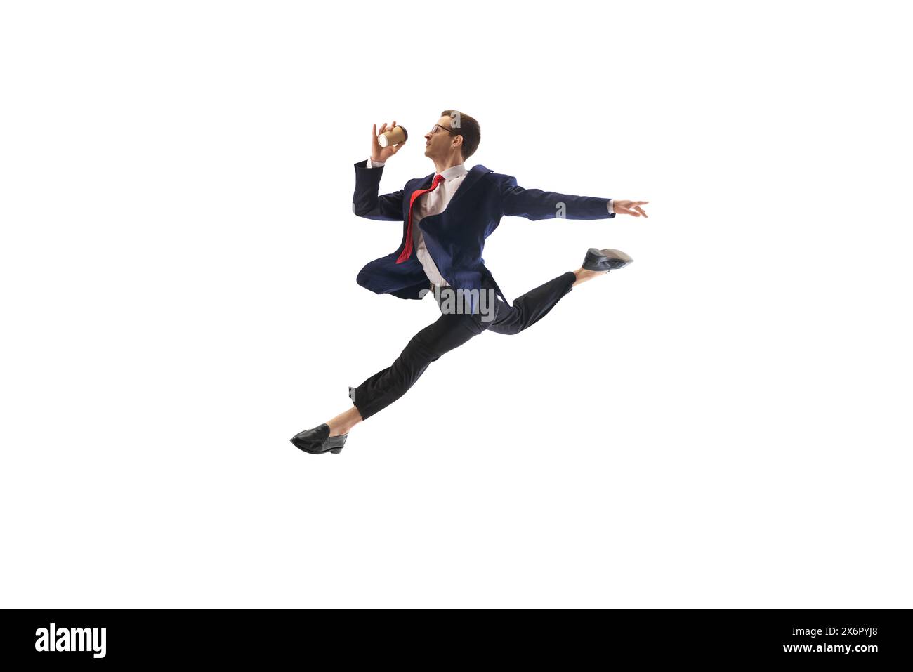 Energetic businessman in mid-leap pose jumping to work, drinking coffee ...