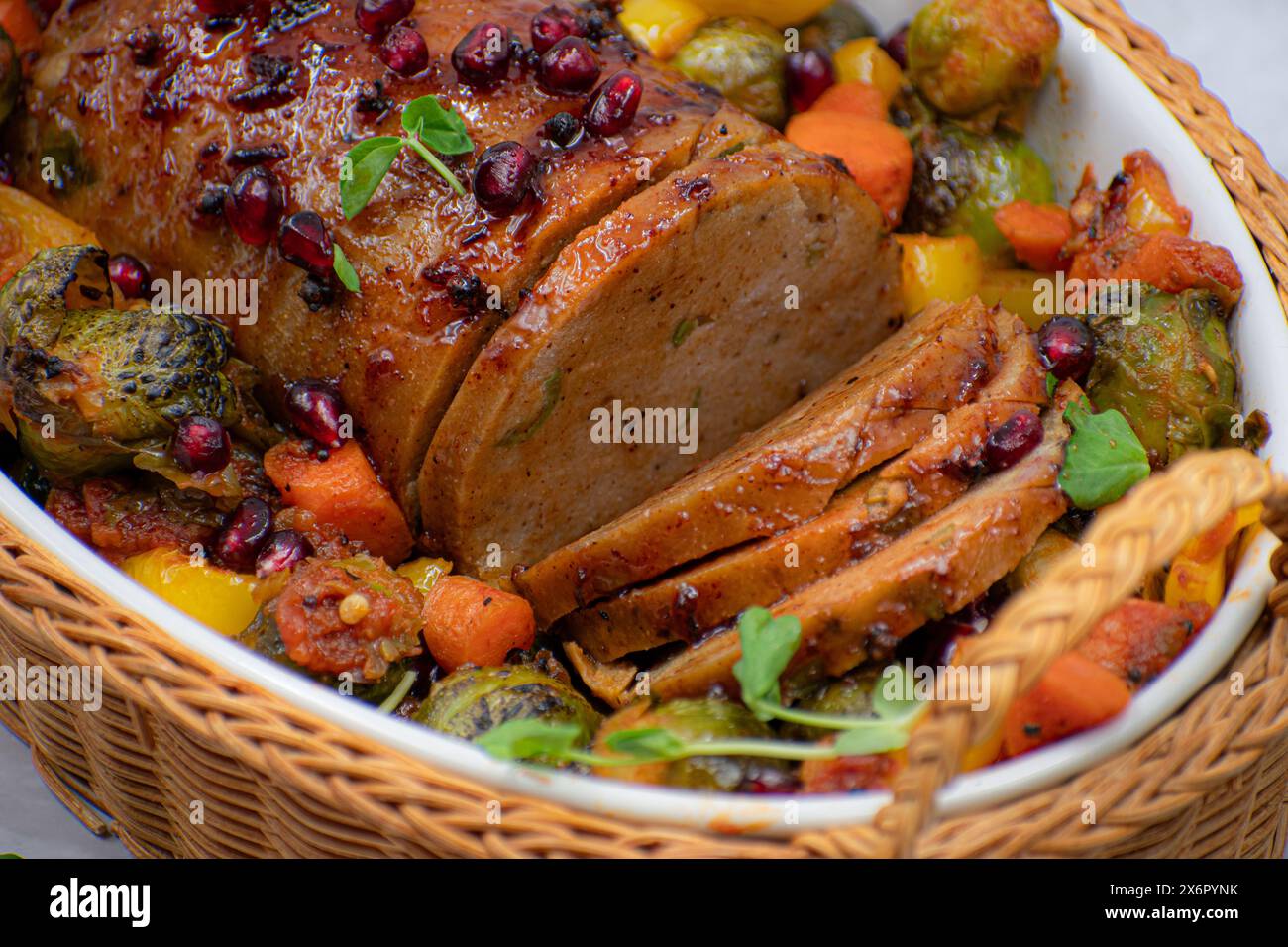 Vegan seitan ham roast, festive meatless dish, along with roasted ...
