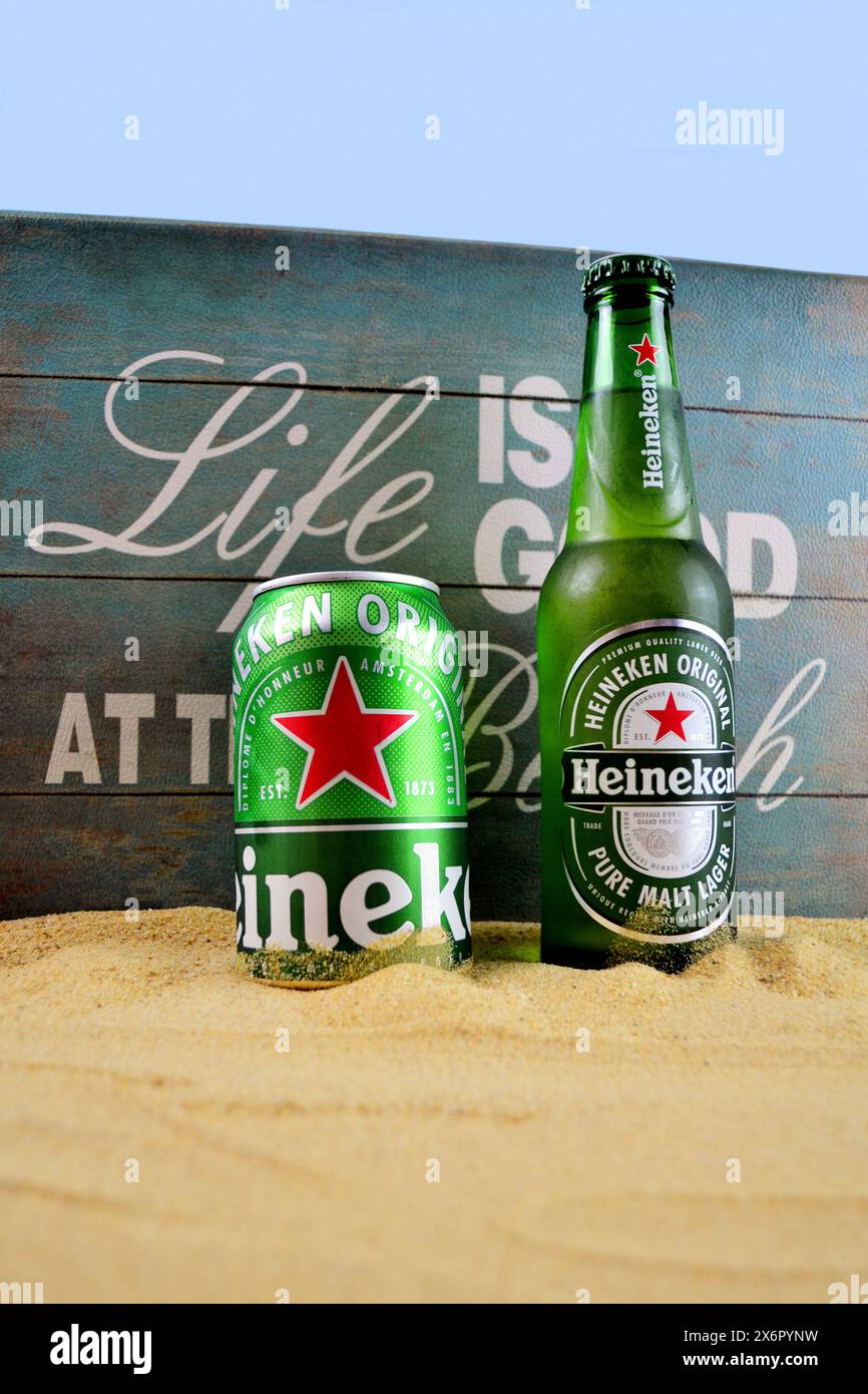 Heineken 33cl bottle and can of lager beer with decorative background ...