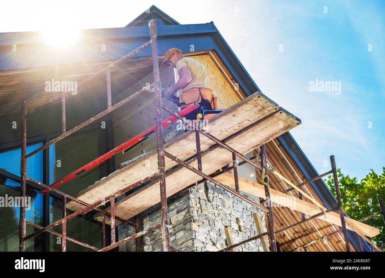 Construction worker making chimney repairs on a building using ...