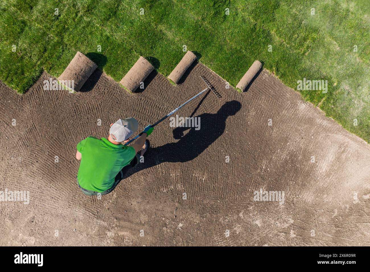 Aerial view of a man maintaining a golf course. Installing new grass ...