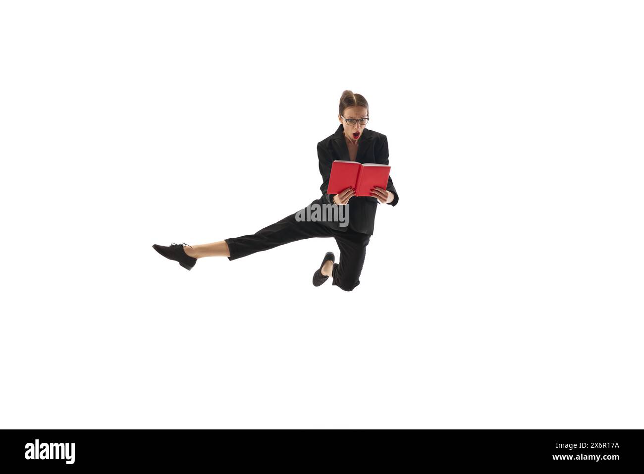 Emotional businesswoman in motion, in mid-air pose jumping with shocked ...