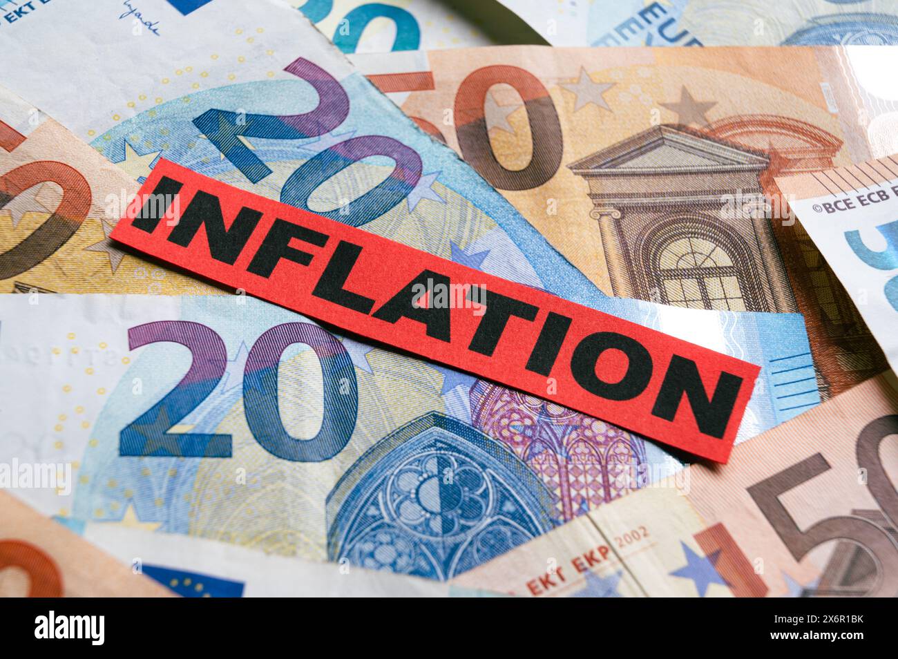 Euro banknotes background, with red ticket with text Inflation Stock ...