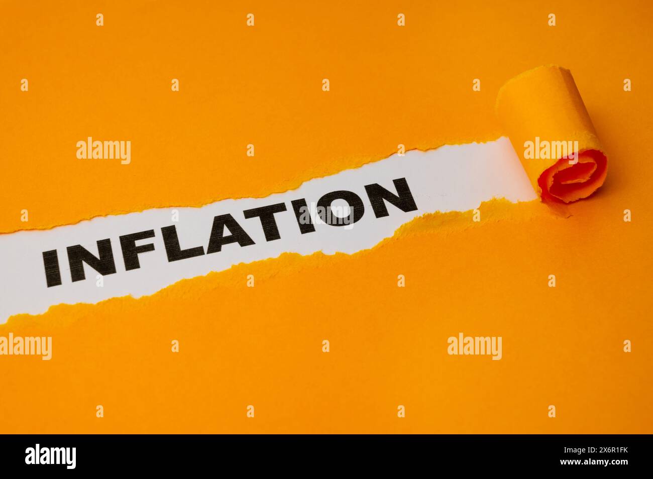 White surface, with the word Inflation in black, underneath torn and ...