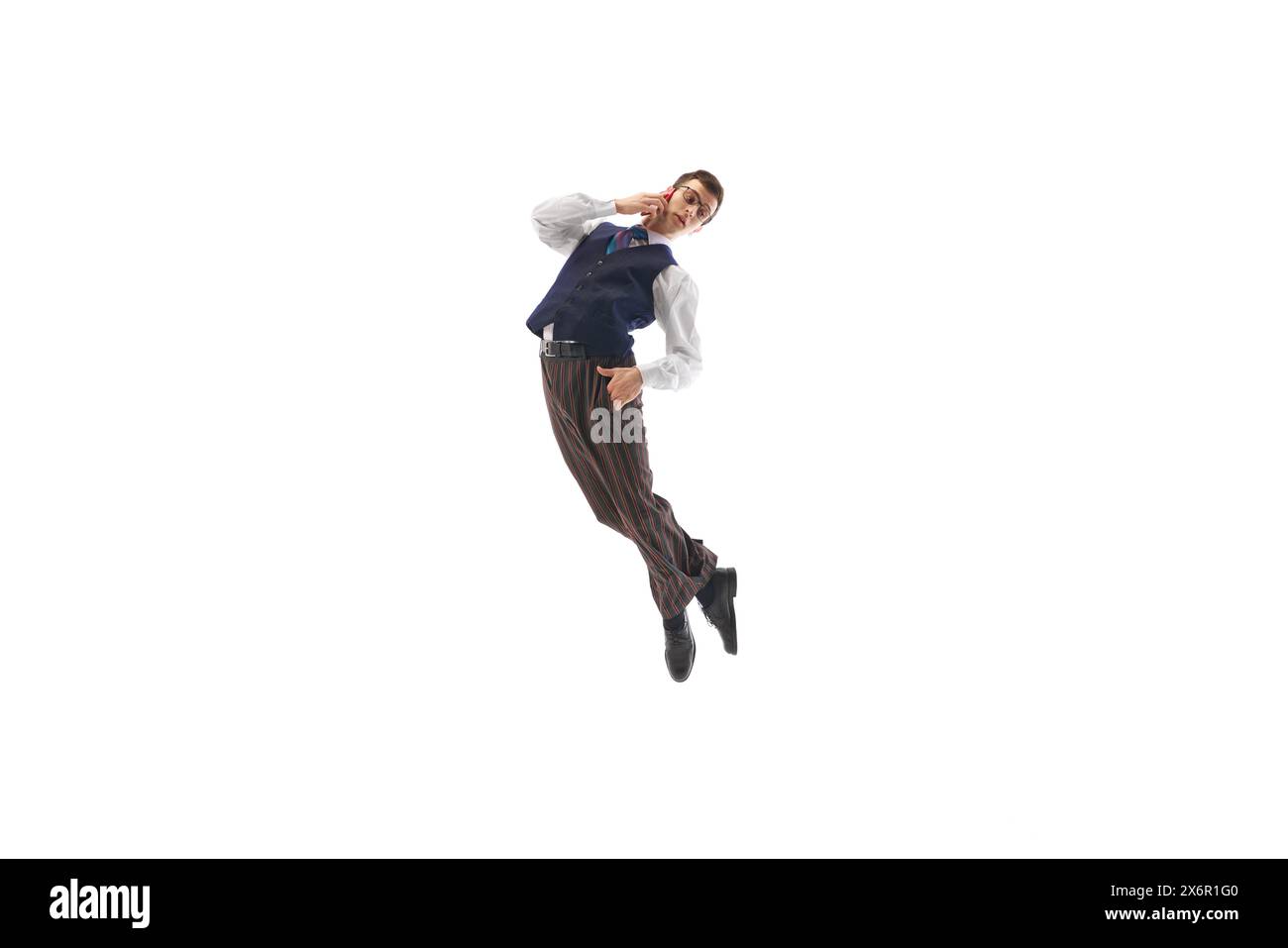 Man, employee in formal wear, jumping and talking on mobile phone ...