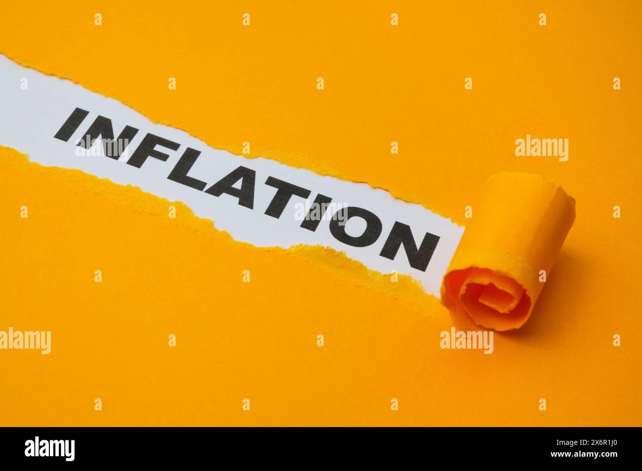 White surface, with the word Inflation in black, underneath torn and ...